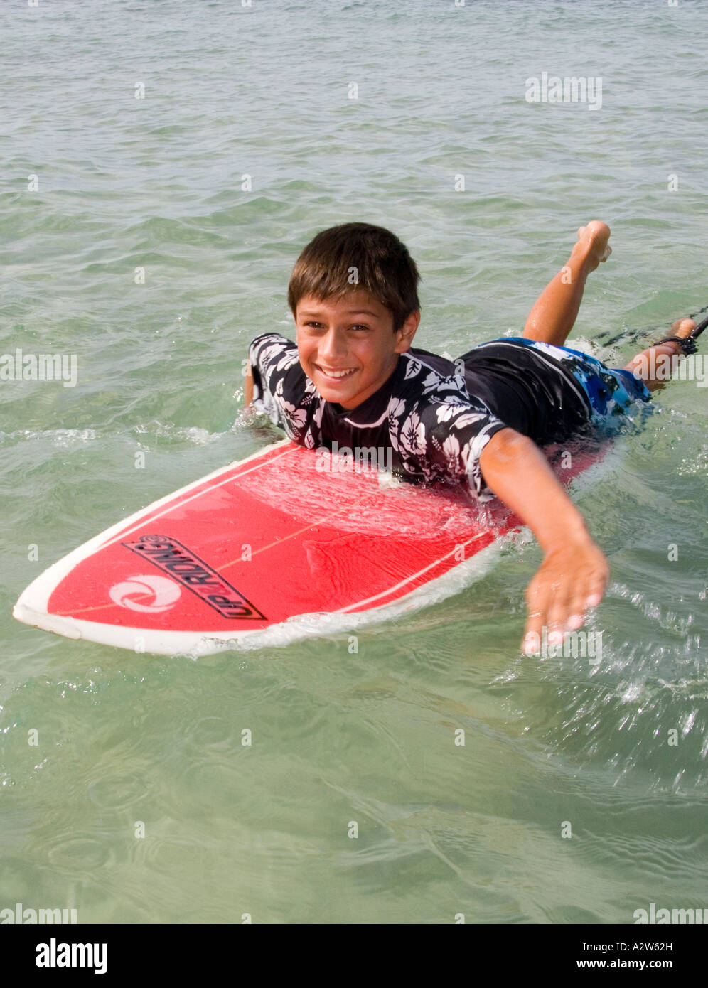 Boy on a surfboard, Waikiki, Oahu, Hawaii Stock Photo - Alamy
