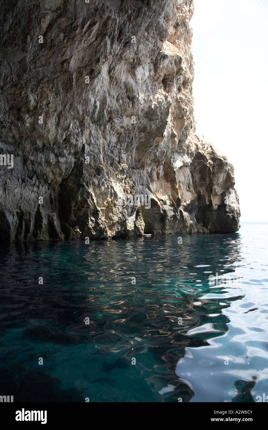 Rock formations in limestone sea cliffs with blue water near the Blue ...