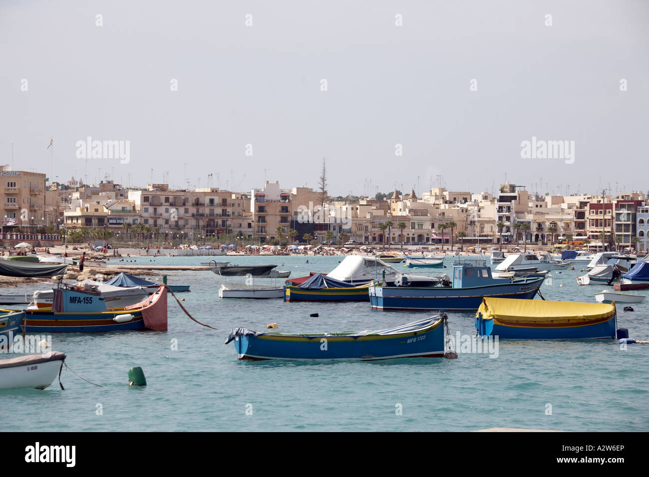 Colourful fishing boats with beach and houses in Pretty Bay Berzebugga ...
