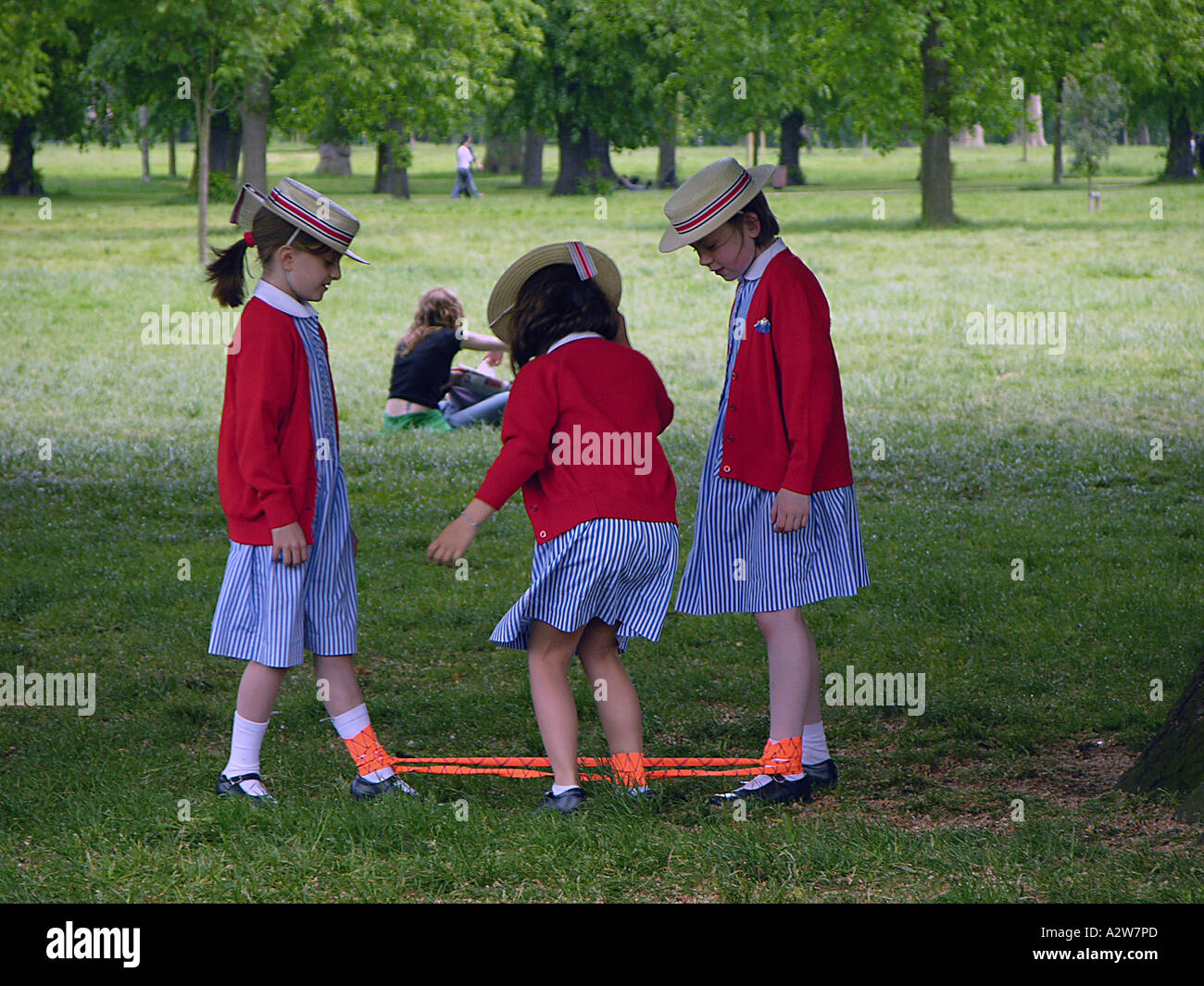 three school girls playing ball in the park London England Stock Photo ...