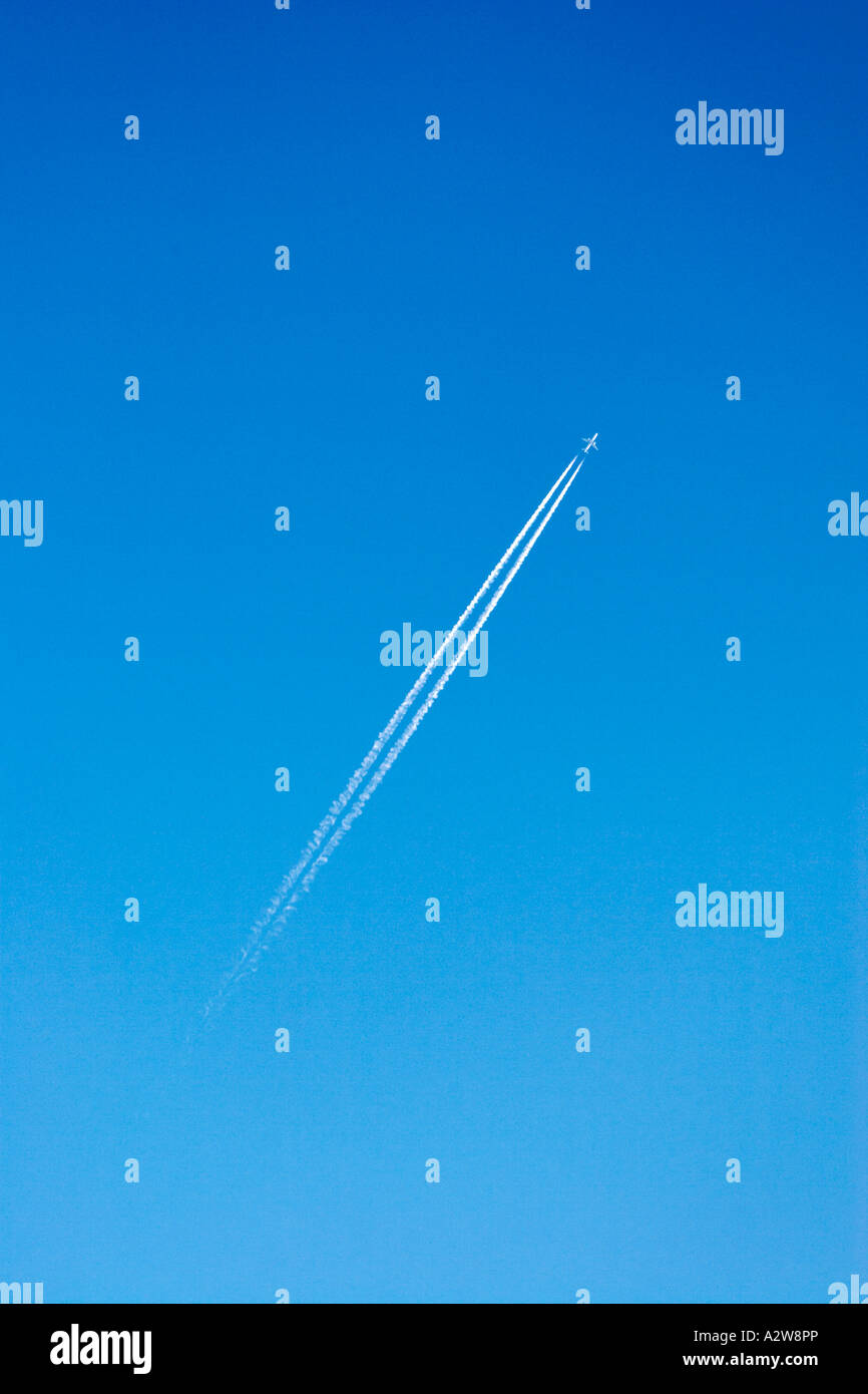 Aircraft contrail or vapour trail against blue sky over London England ...