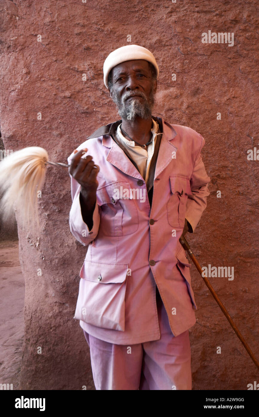 Security guard man in pink suit with cane standing outside Bet ...