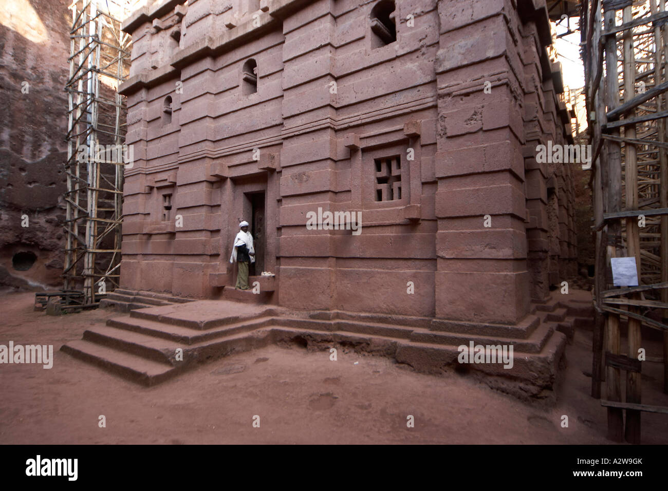 Priest outside Bet Amanuel St Emmanuel finely cut rock hewn Orthodox ...