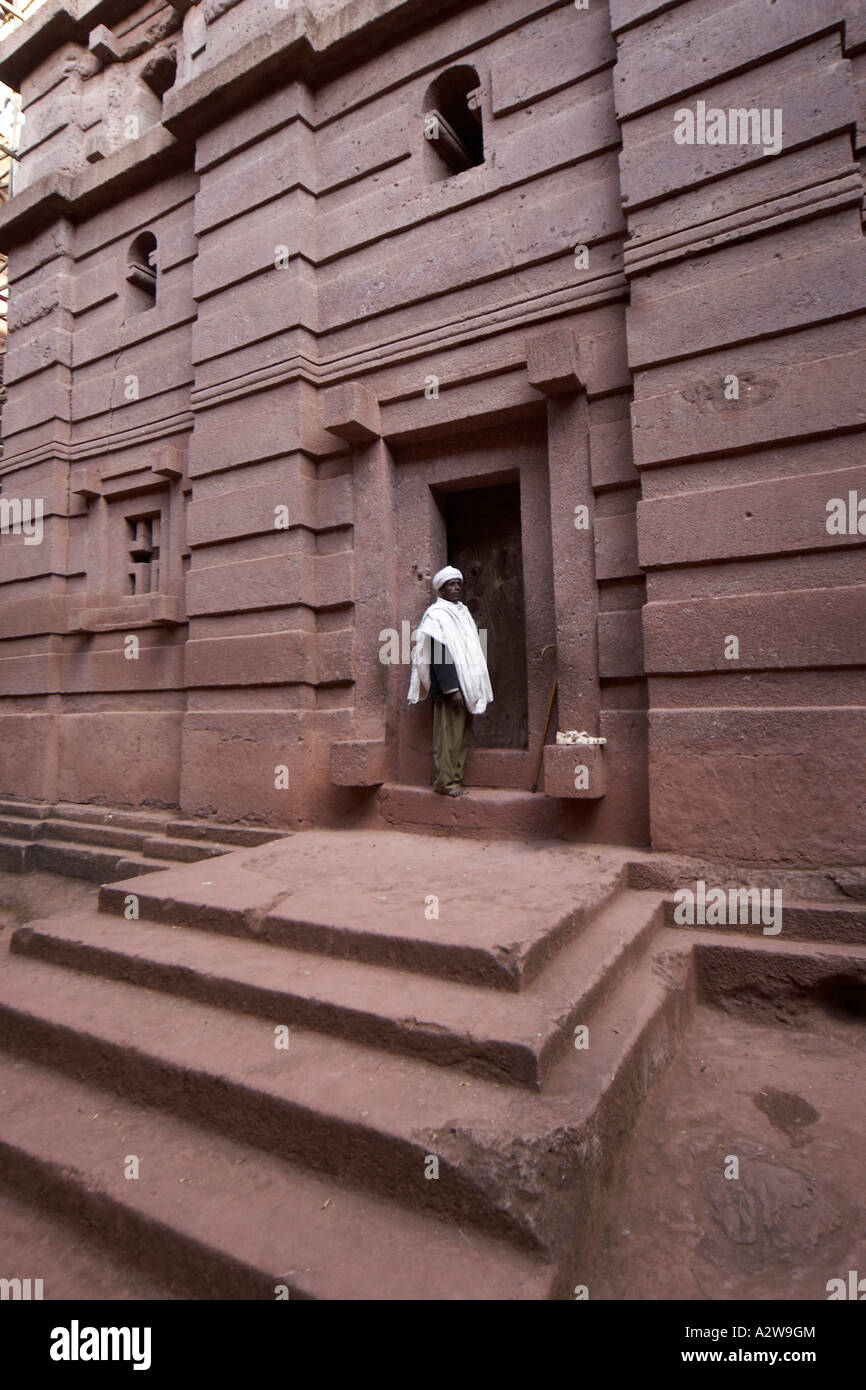 Priest outside Bet Amanuel St Emmanuel finely cut rock hewn Orthodox ...