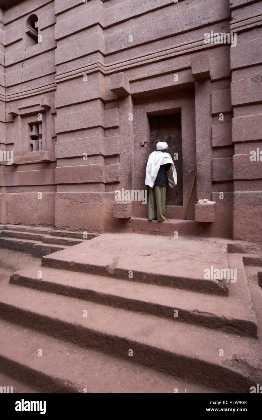 Priest outside Bet Amanuel St Emmanuel finely cut rock hewn Orthodox ...