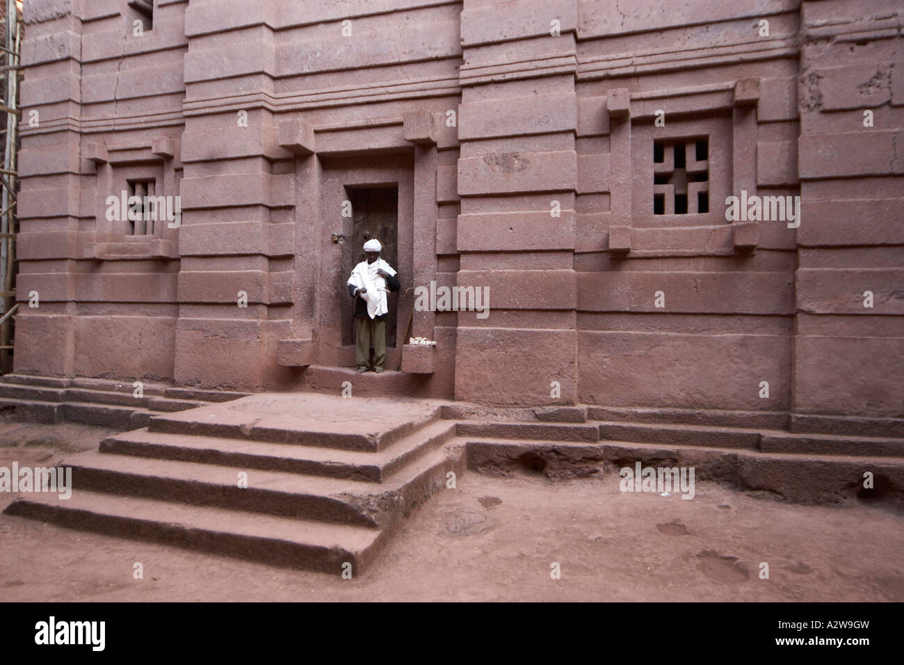 Priest outside Bet Amanuel St Emmanuel finely cut rock hewn Orthodox ...