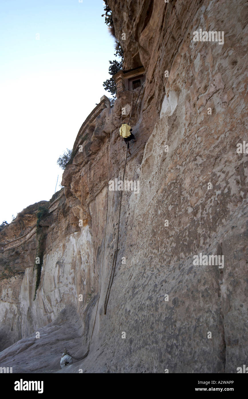 Monk or priest climbing ascending or descending rope to Debre Damo ...
