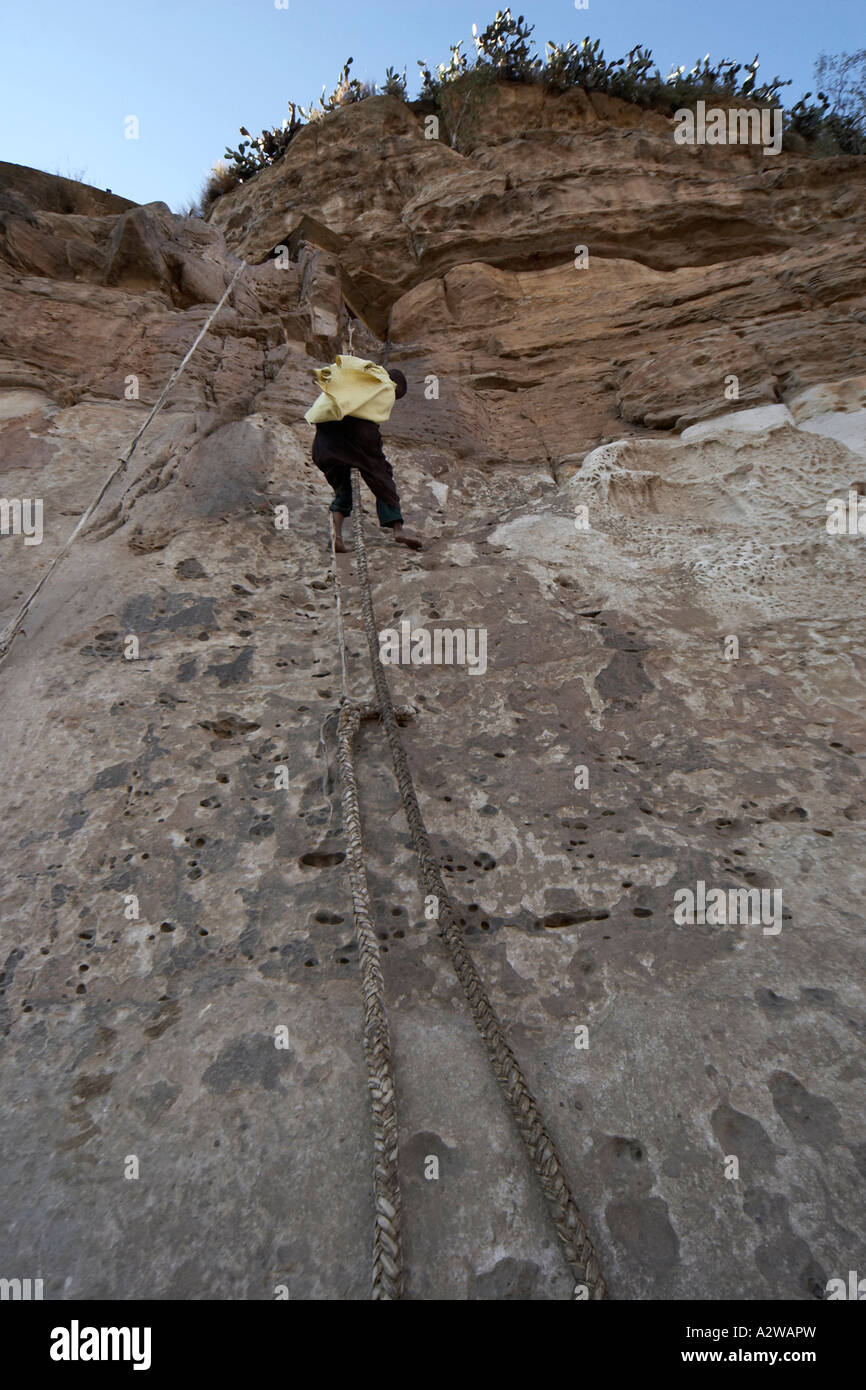 Monk or priest climbing ascending or descending rope to Debre Damo ...
