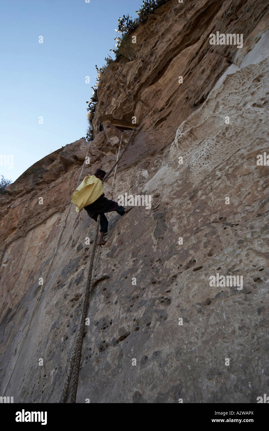 Monk or priest climbing ascending or descending rope to Debre Damo ...