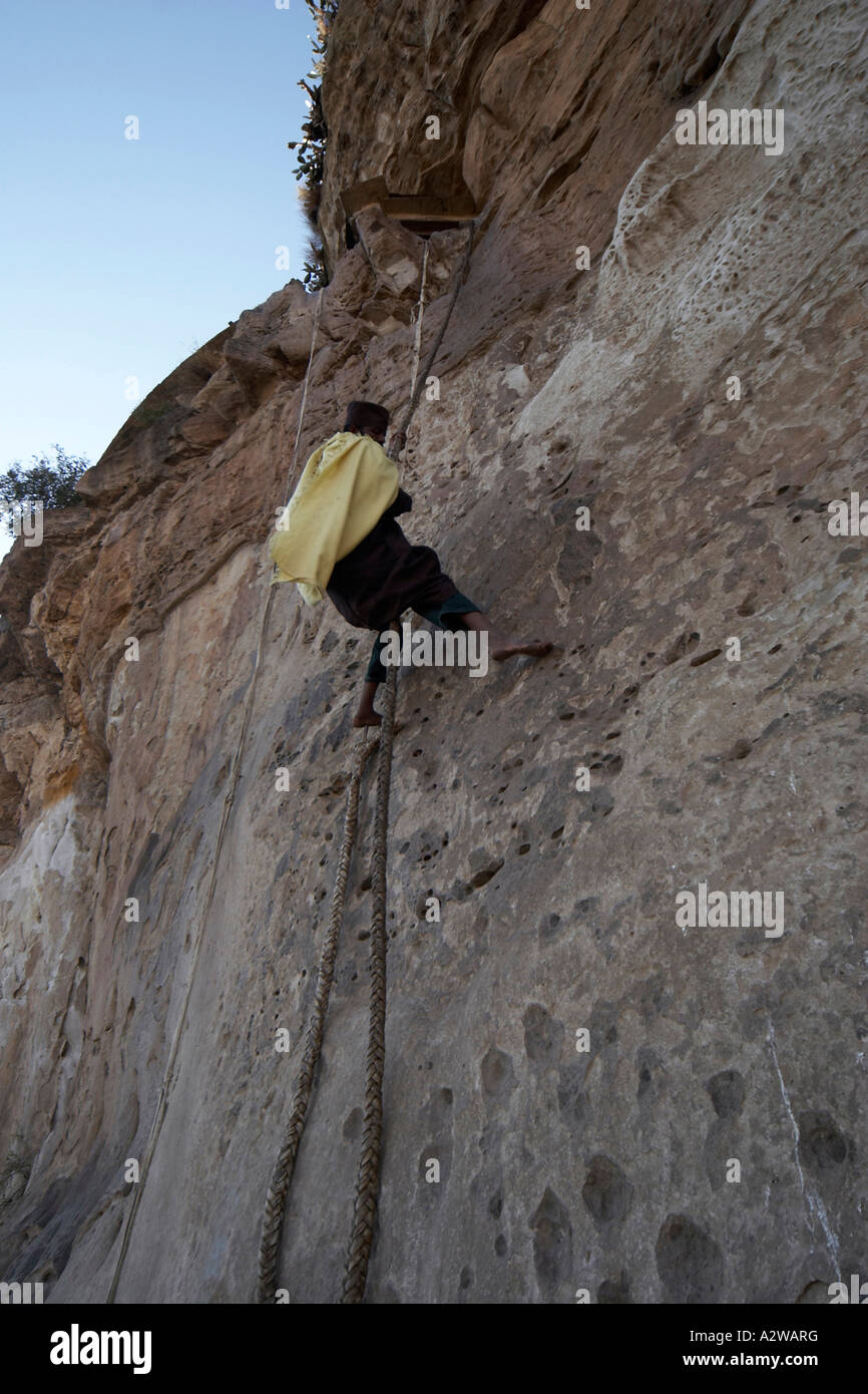 Monk or priest climbing ascending or descending rope to Debre Damo ...