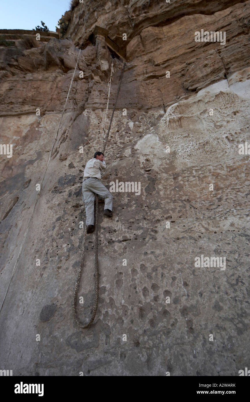 Monk or priest climbing ascending or descending rope to Debre Damo ...