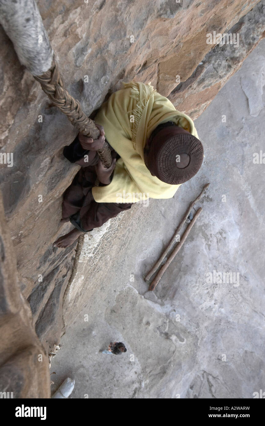 Monk or priest climbing ascending or descending rope to Debre Damo ...