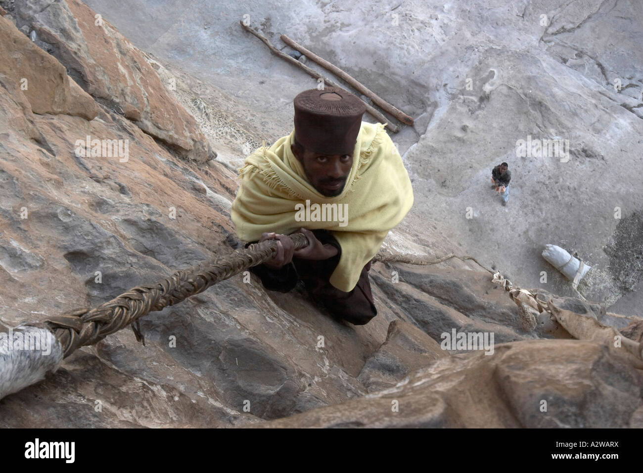 Monk or priest climbing ascending or descending rope to Debre Damo ...