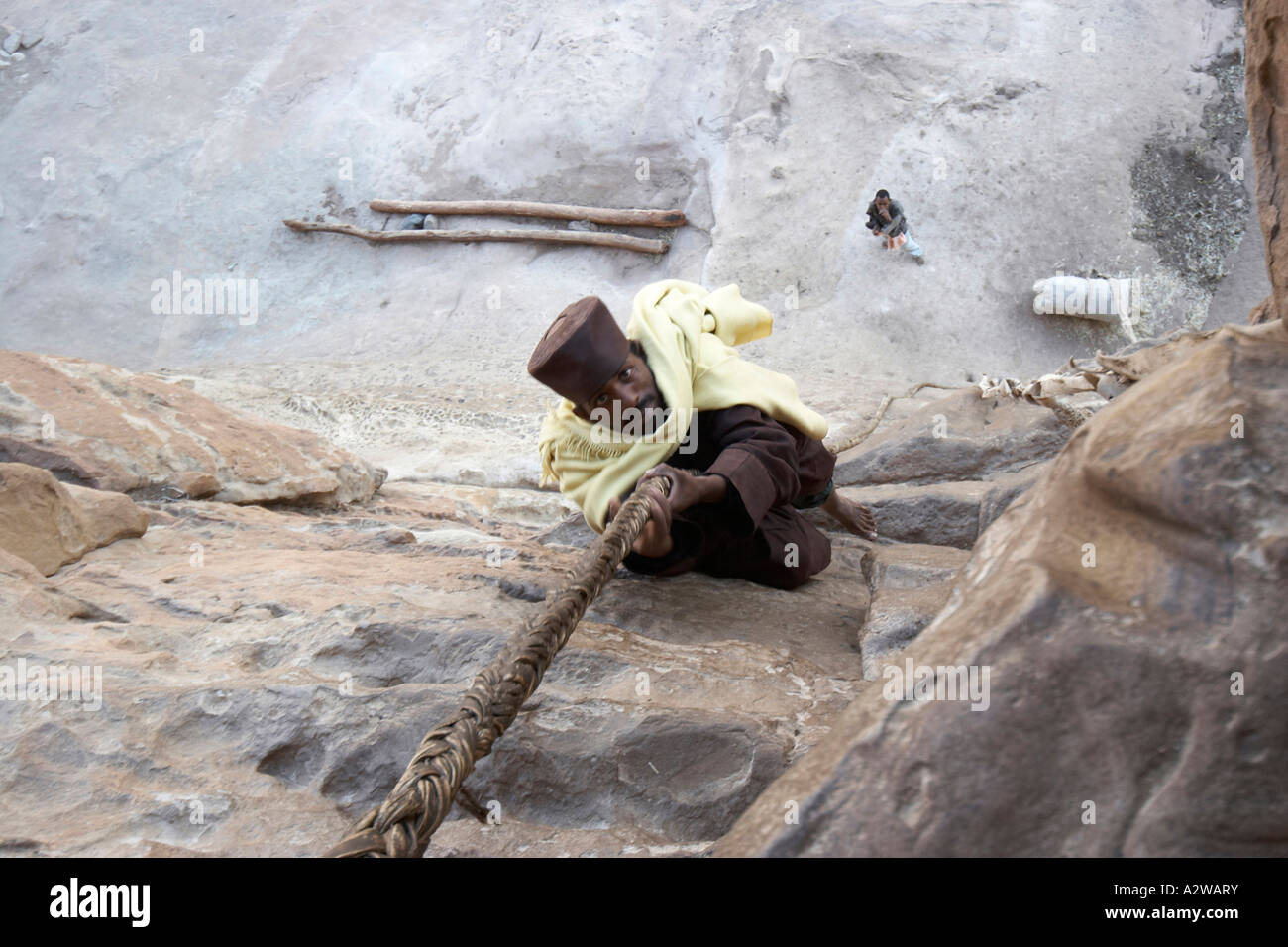Monk or priest climbing ascending or descending rope to Debre Damo ...