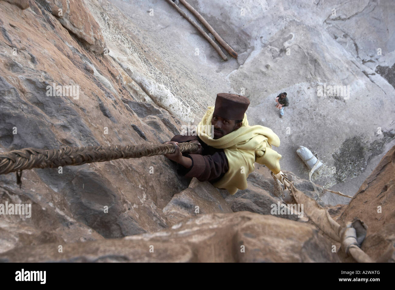 Monk or priest climbing ascending or descending rope to Debre Damo ...