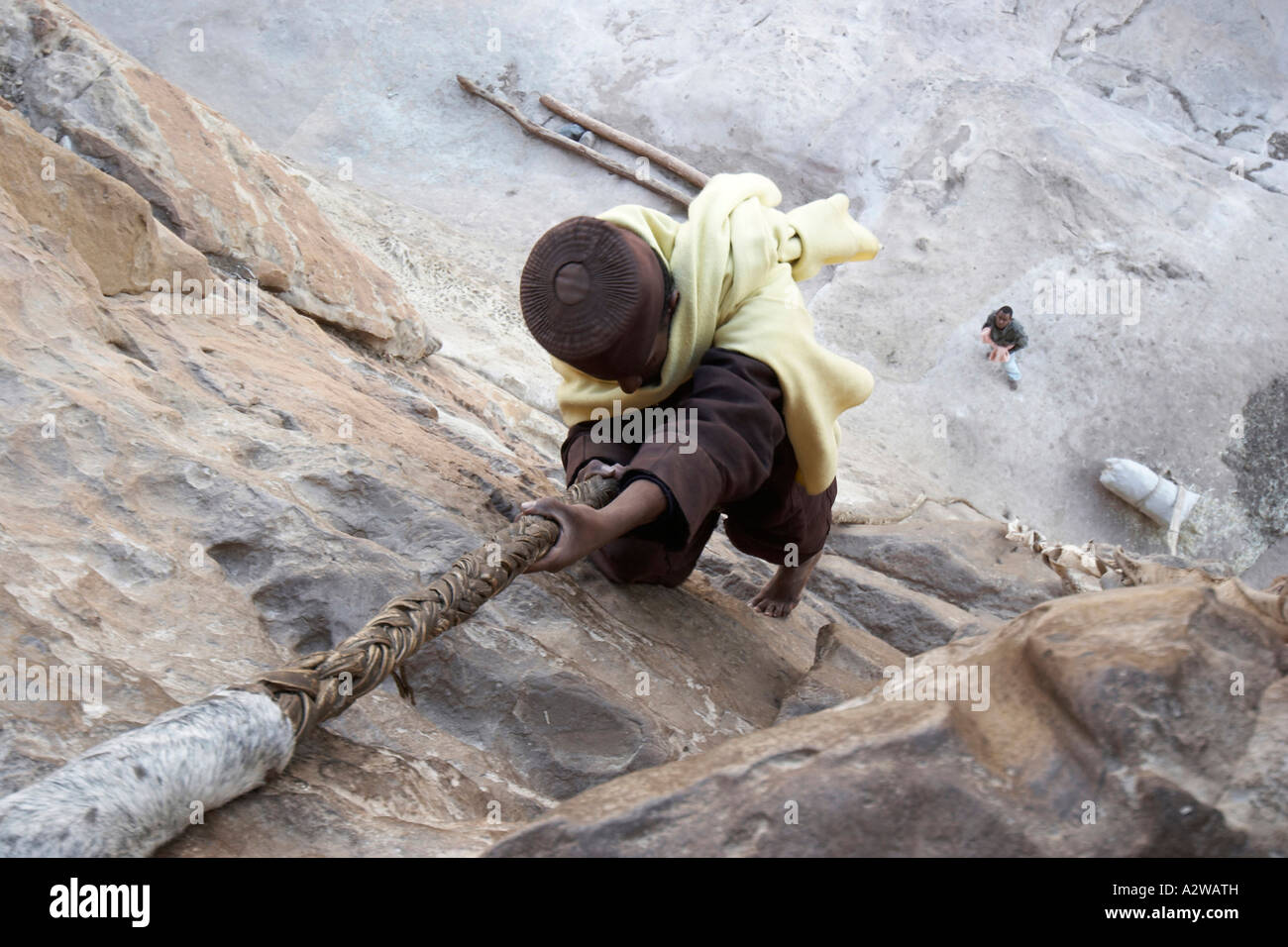 Monk or priest climbing ascending or descending rope to Debre Damo ...