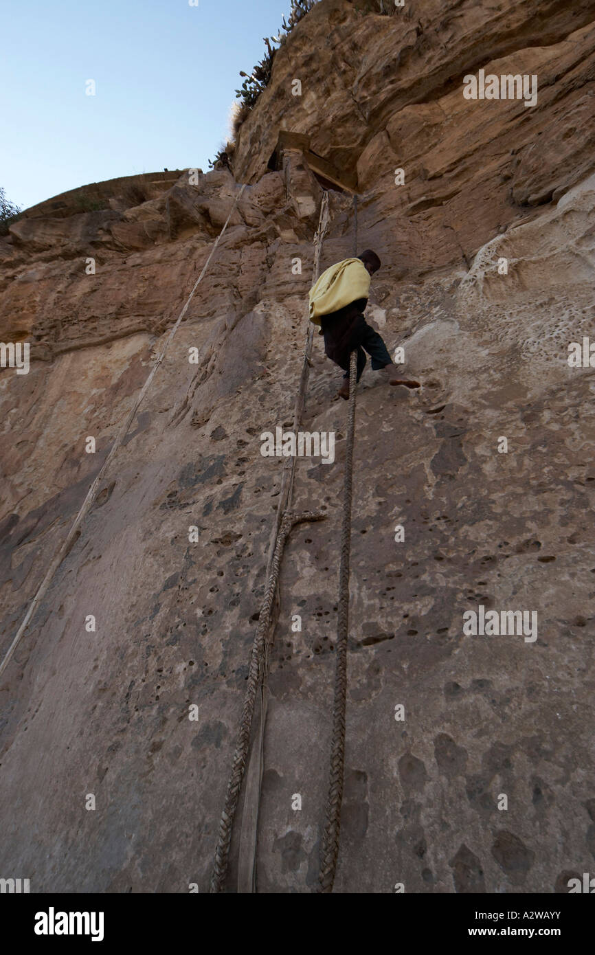 Monk or priest climbing ascending or descending rope to Debre Damo ...