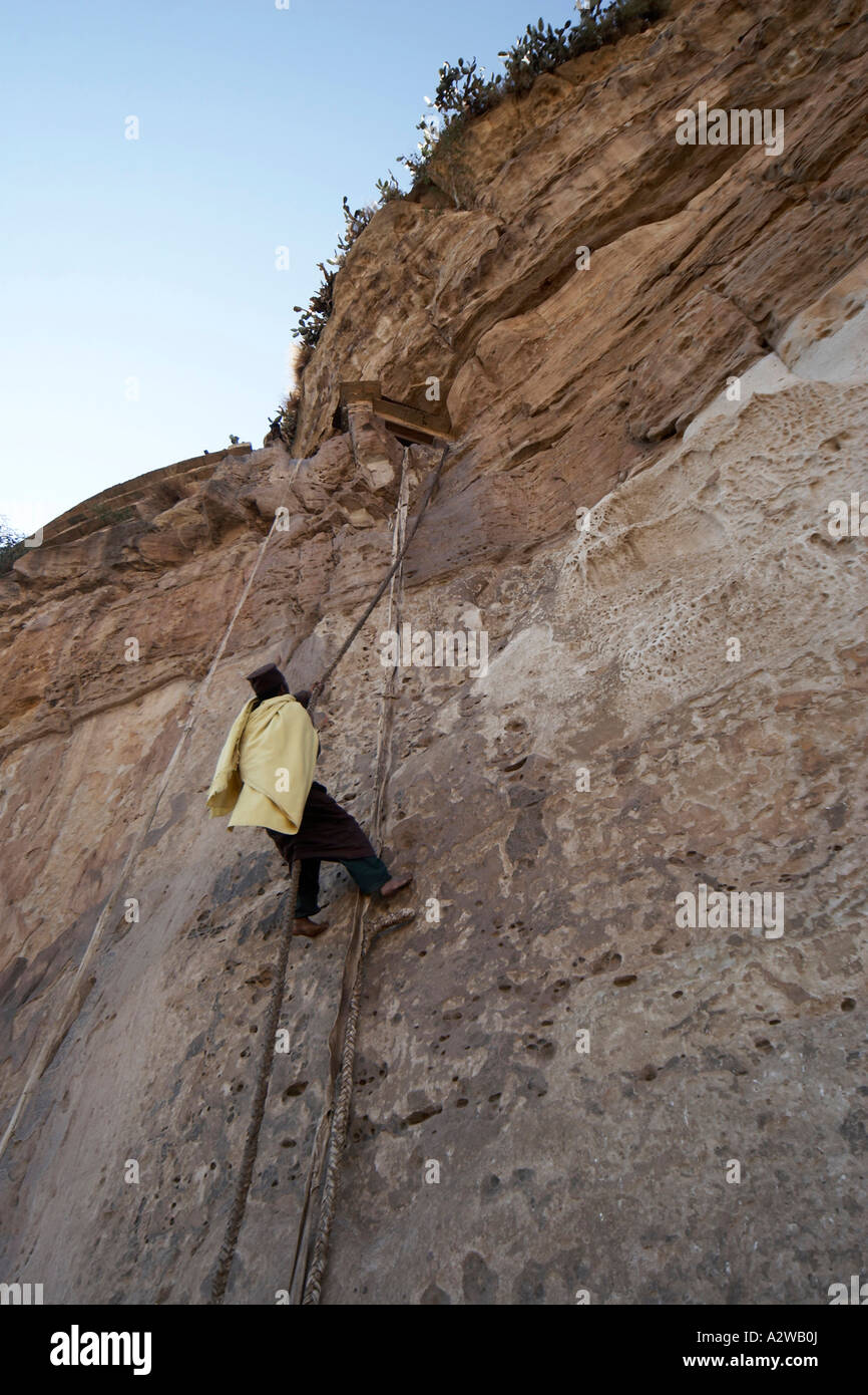 Monk or priest climbing ascending or descending rope to Debre Damo ...