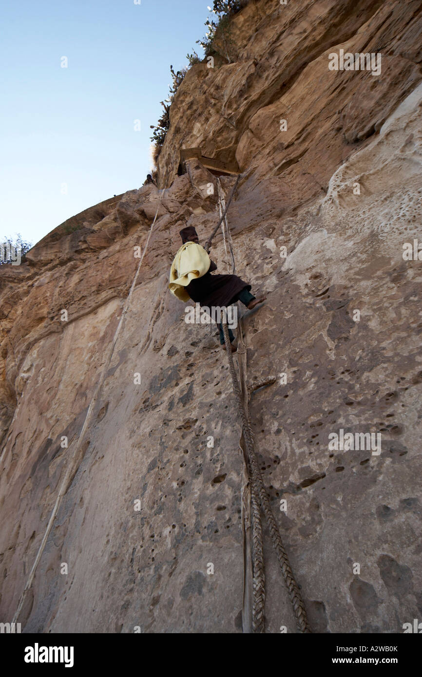 Monk or priest climbing ascending or descending rope to Debre Damo ...