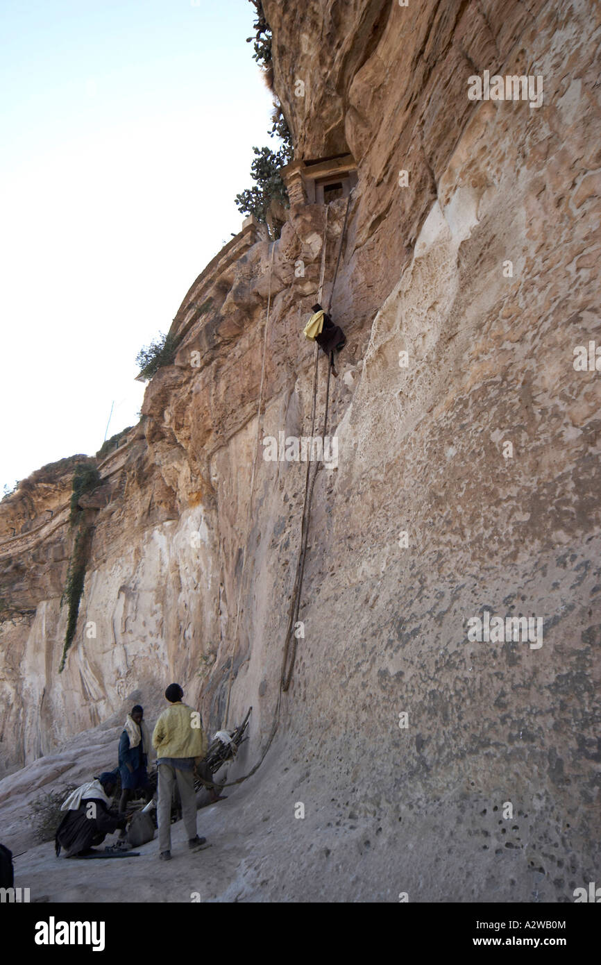 Monk or priest climbing ascending or descending rope to Debre Damo ...