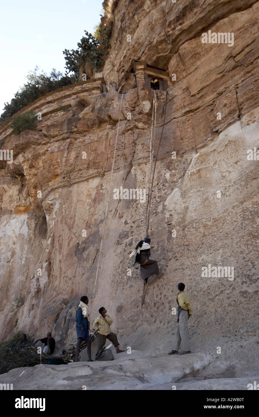 Monk or priest climbing ascending or descending rope to Debre Damo ...