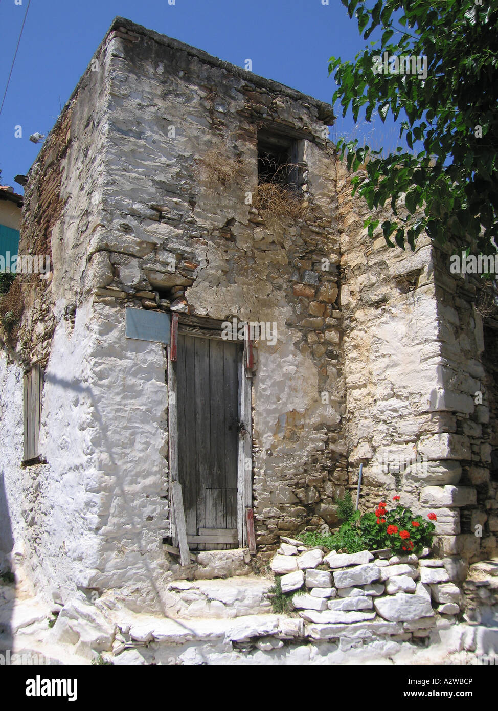 Old stone cottage with red geraniums Alonissos Alonisos Greece Stock ...