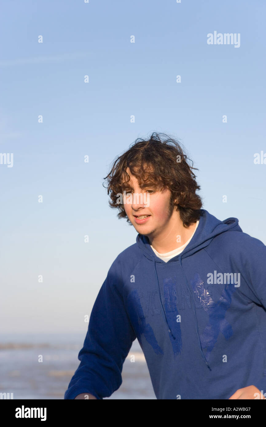 Teenage Boy Running on Beach Stock Photo - Alamy
