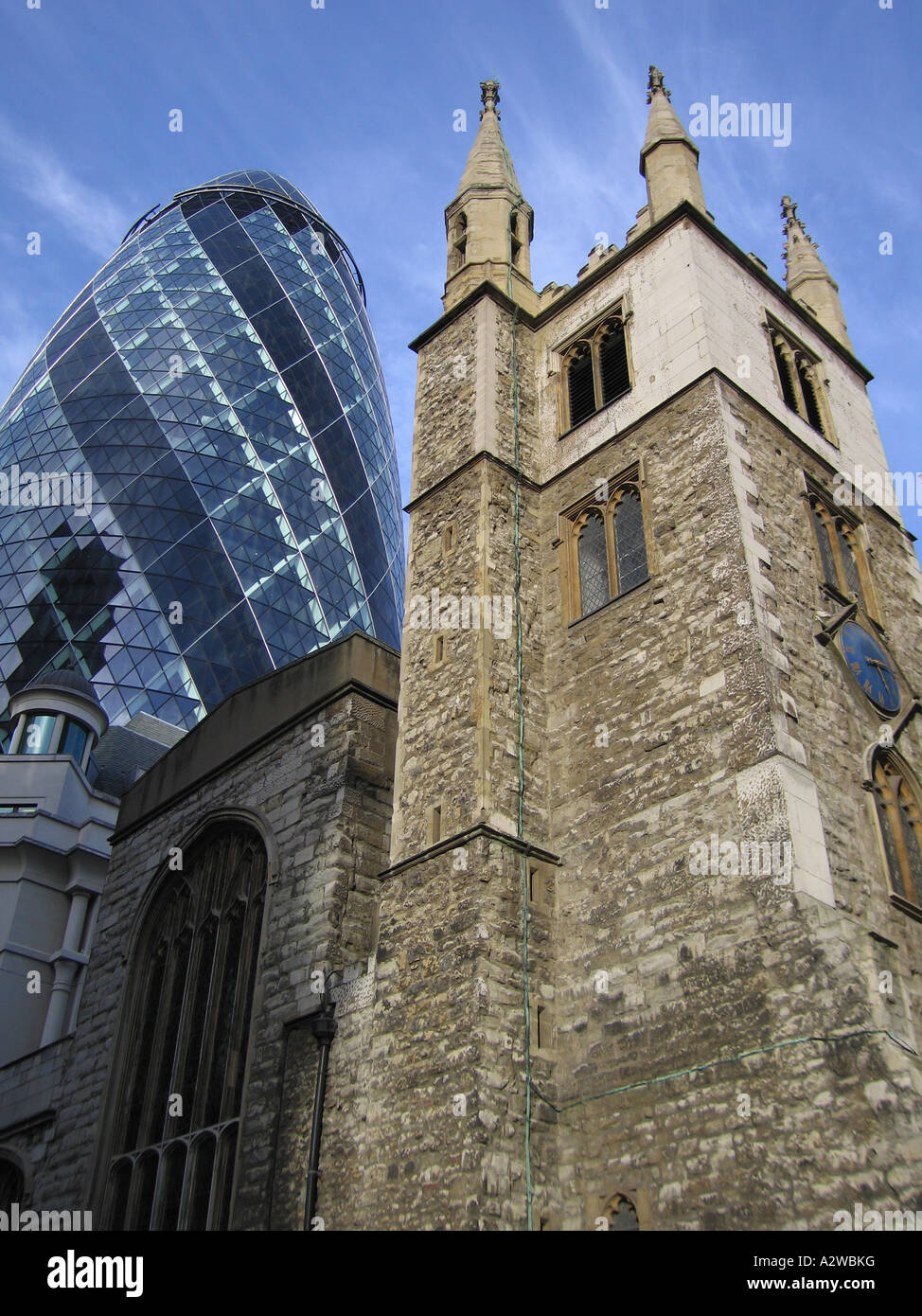 The glass offices of the Swiss Re Gherkin rising from behind historic ...