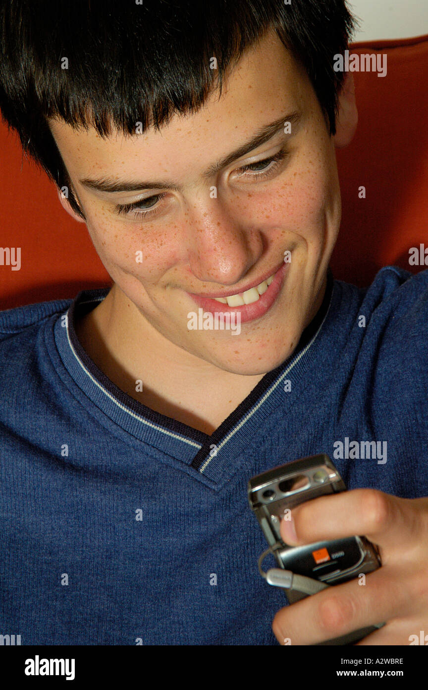 Teenage boy receiving an SMS on cellphone Stock Photo - Alamy
