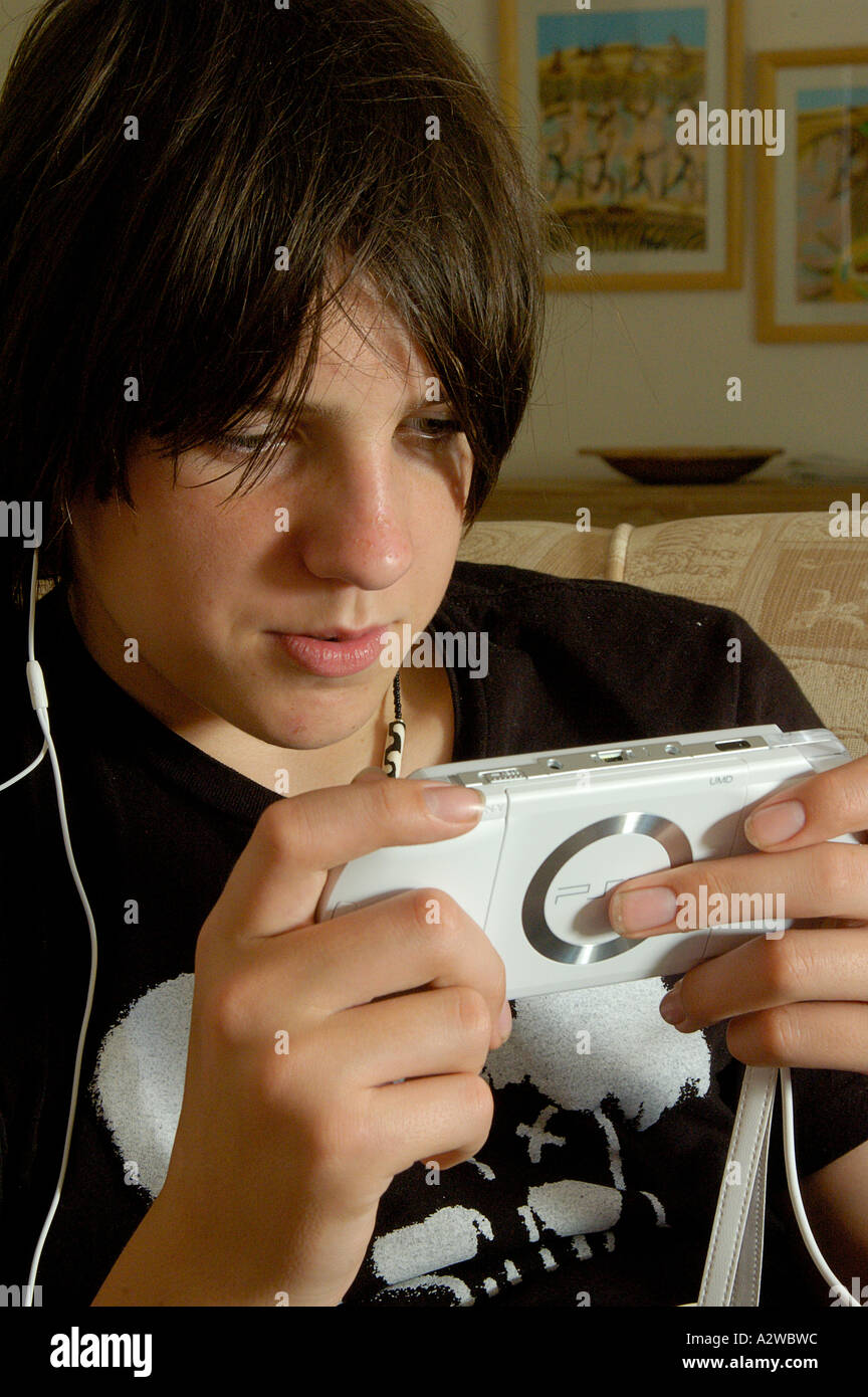 Teenage boy playing with Playstation Stock Photo - Alamy