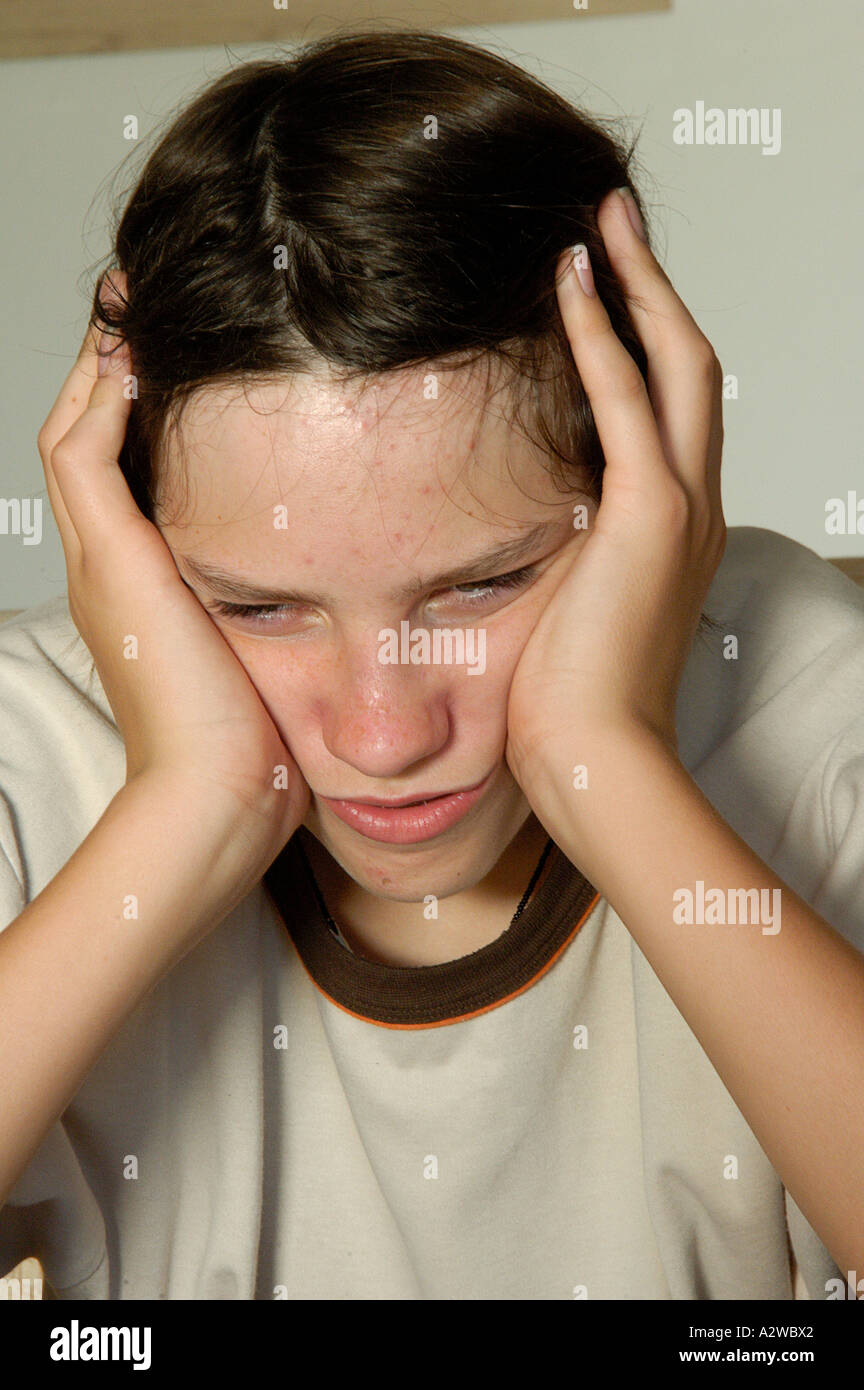 Teenage boy looking very fed up Stock Photo - Alamy
