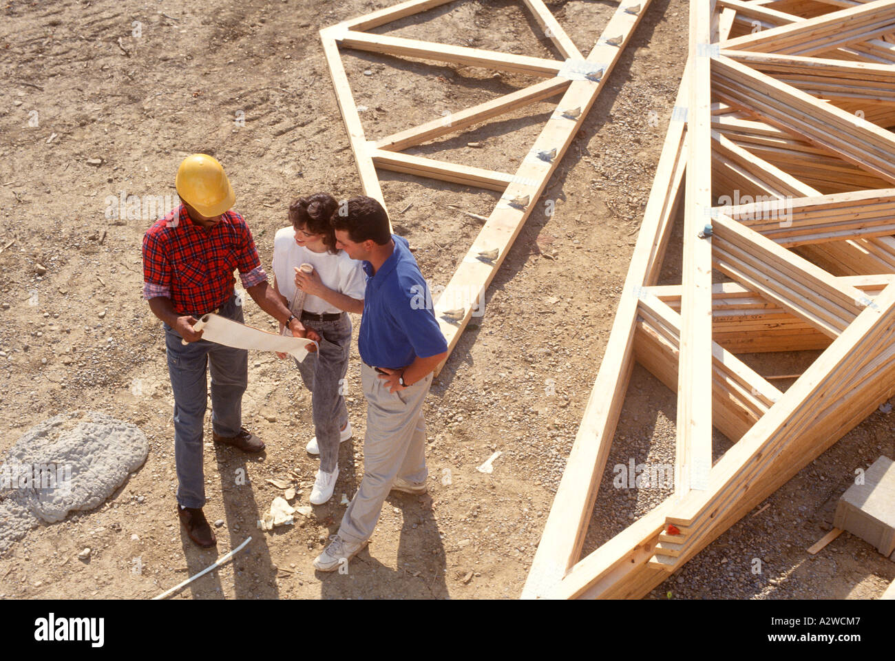 Couple and architect look over plans for a new home Stock Photo - Alamy