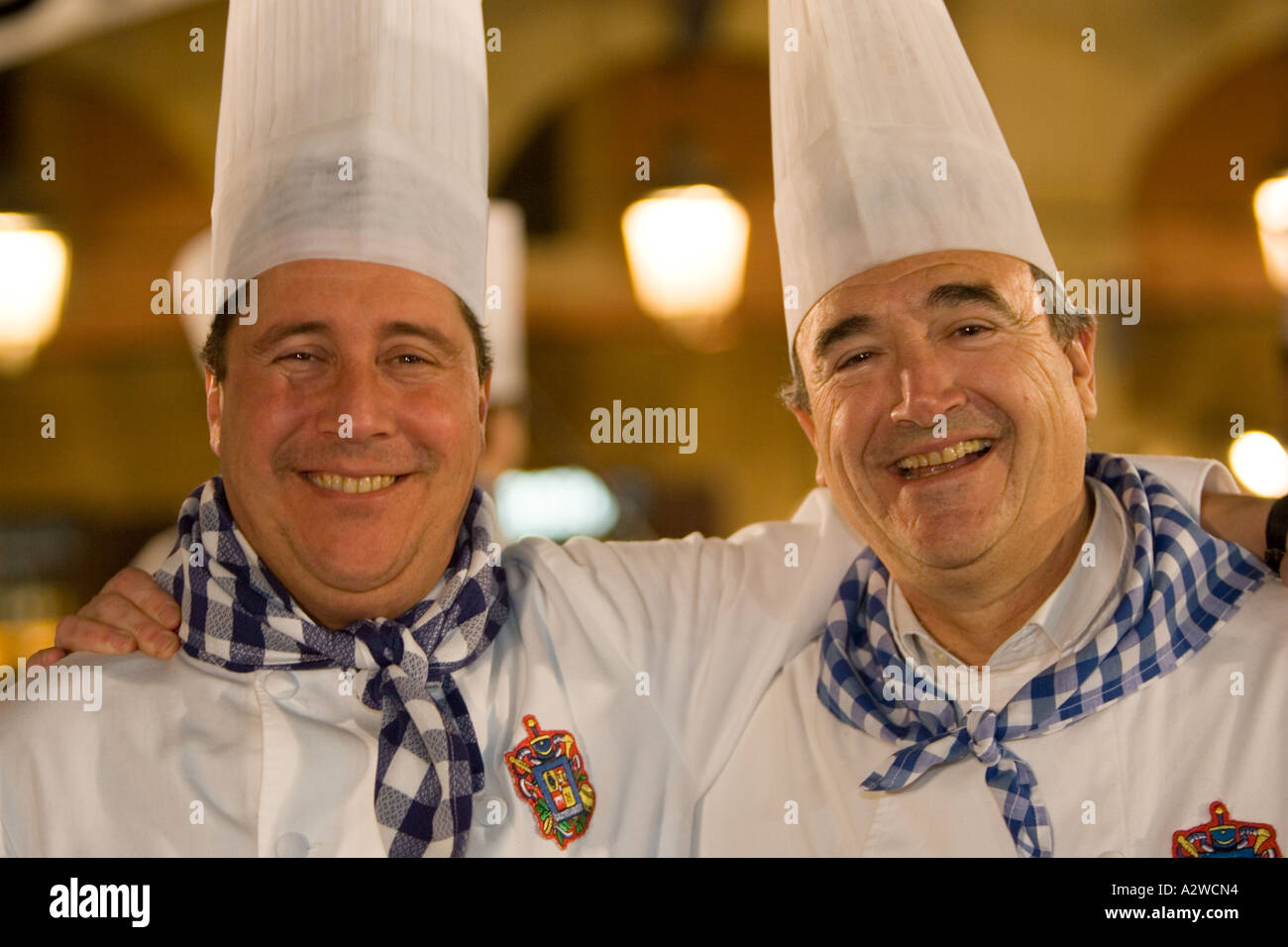 Two Basque men wearing white chefs outfits at night during La ...