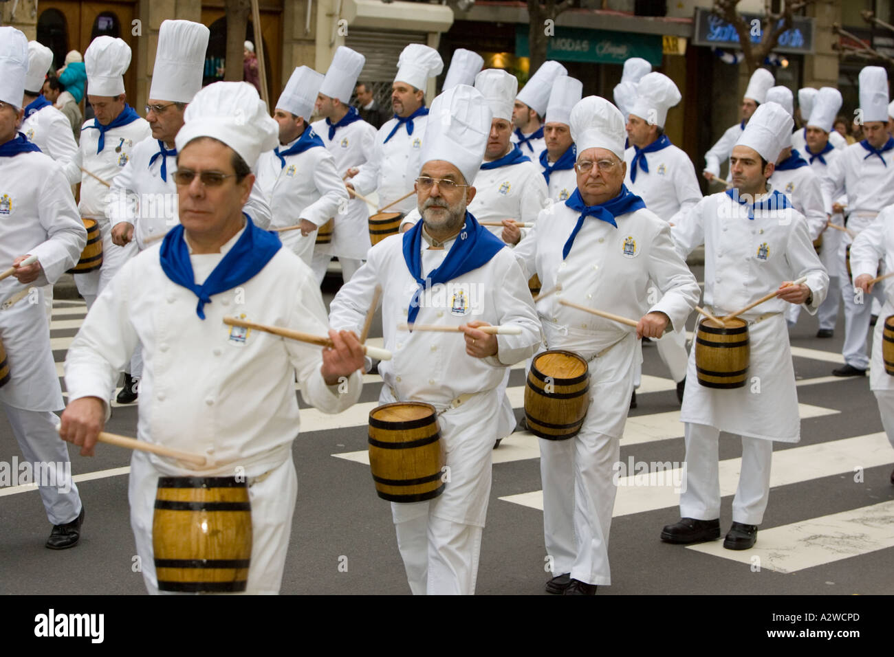 Men wearing white chefs outfits parade during La Tamborrada, Donostia ...