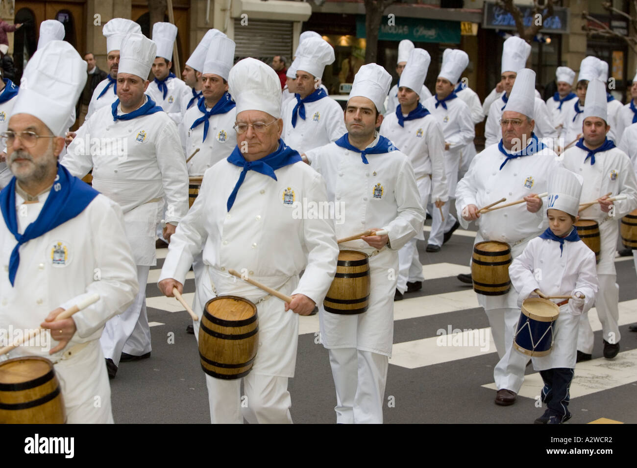 Men wearing white chefs outfits parade during La Tamborrada, Donostia ...
