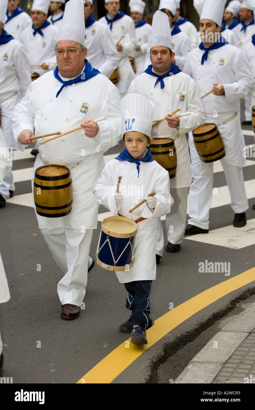 Men wearing white chefs outfits parade during La Tamborrada, Donostia ...