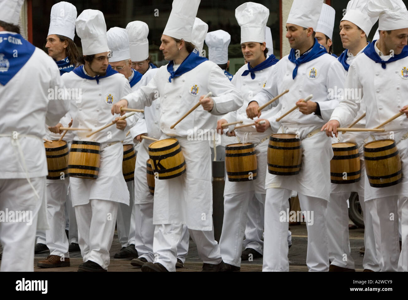 Basque men in white chefs outfits drumming on barrels, La Tamborrada ...