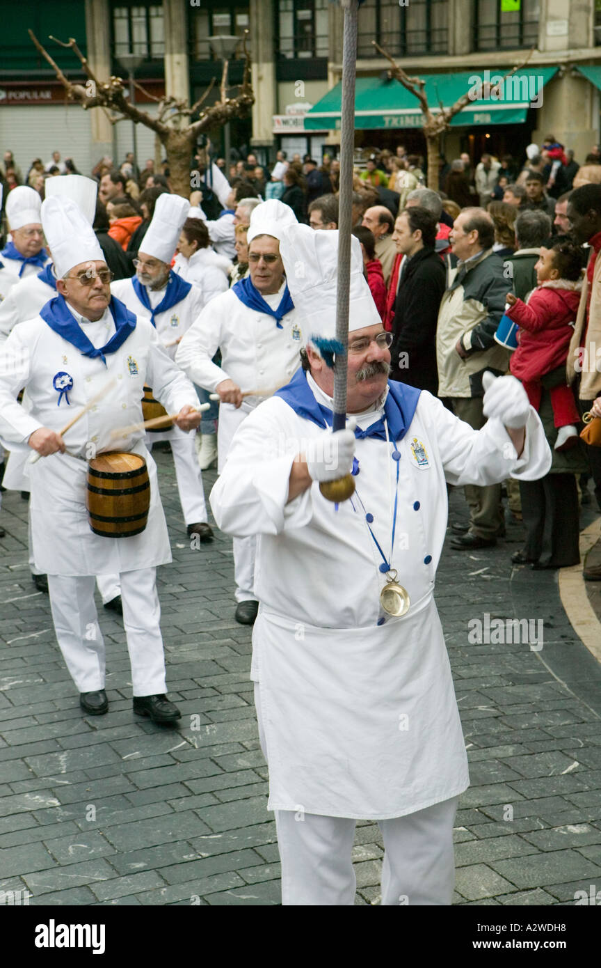 Basque men wearing white chefs outfits parade, La Tamborrada, Donostia ...