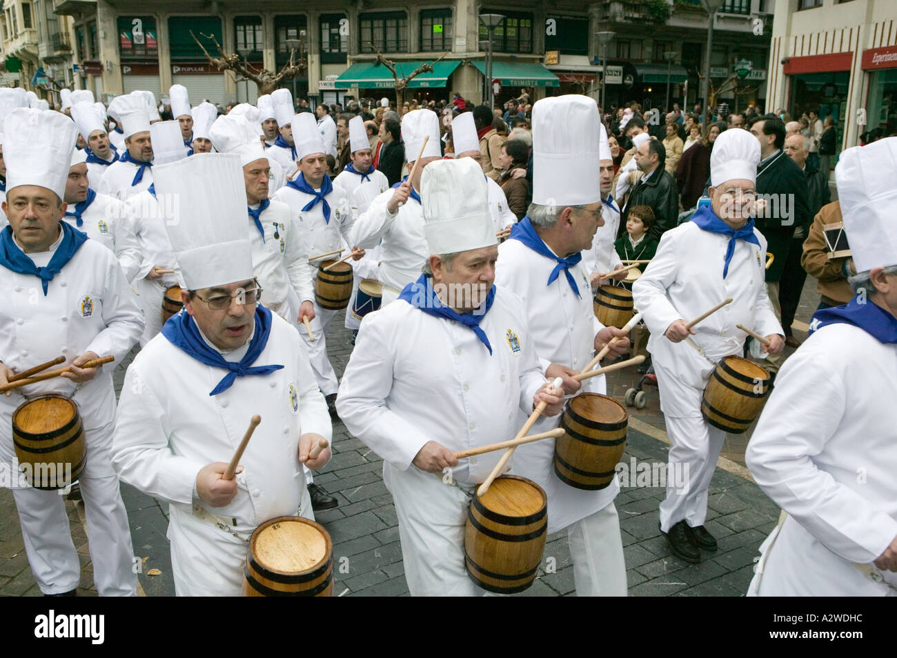 Basque men wearing white chefs outfits drumming on wooden barrels, La ...