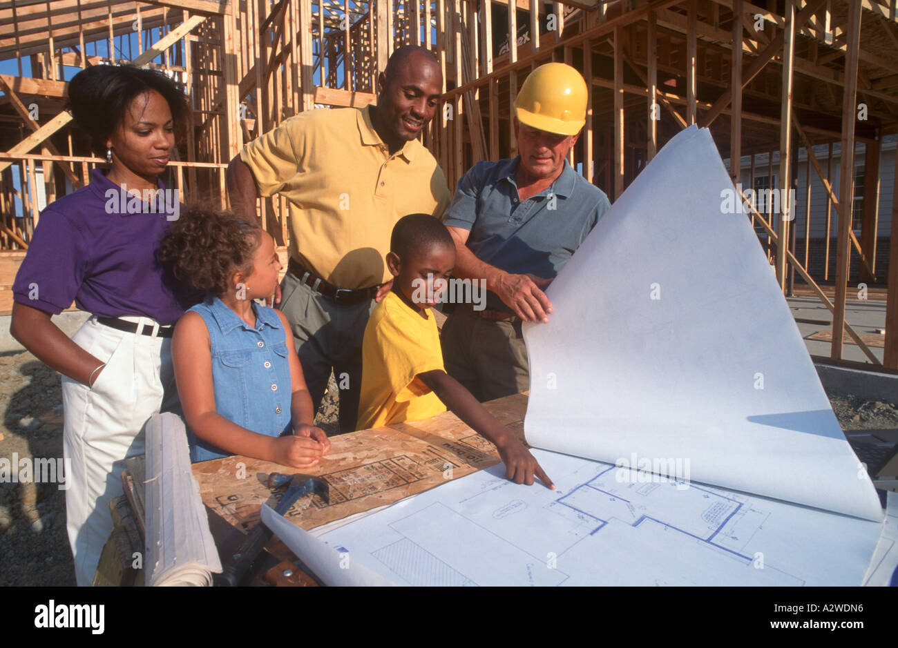 Family looks at plans during with contractor house construction Stock ...