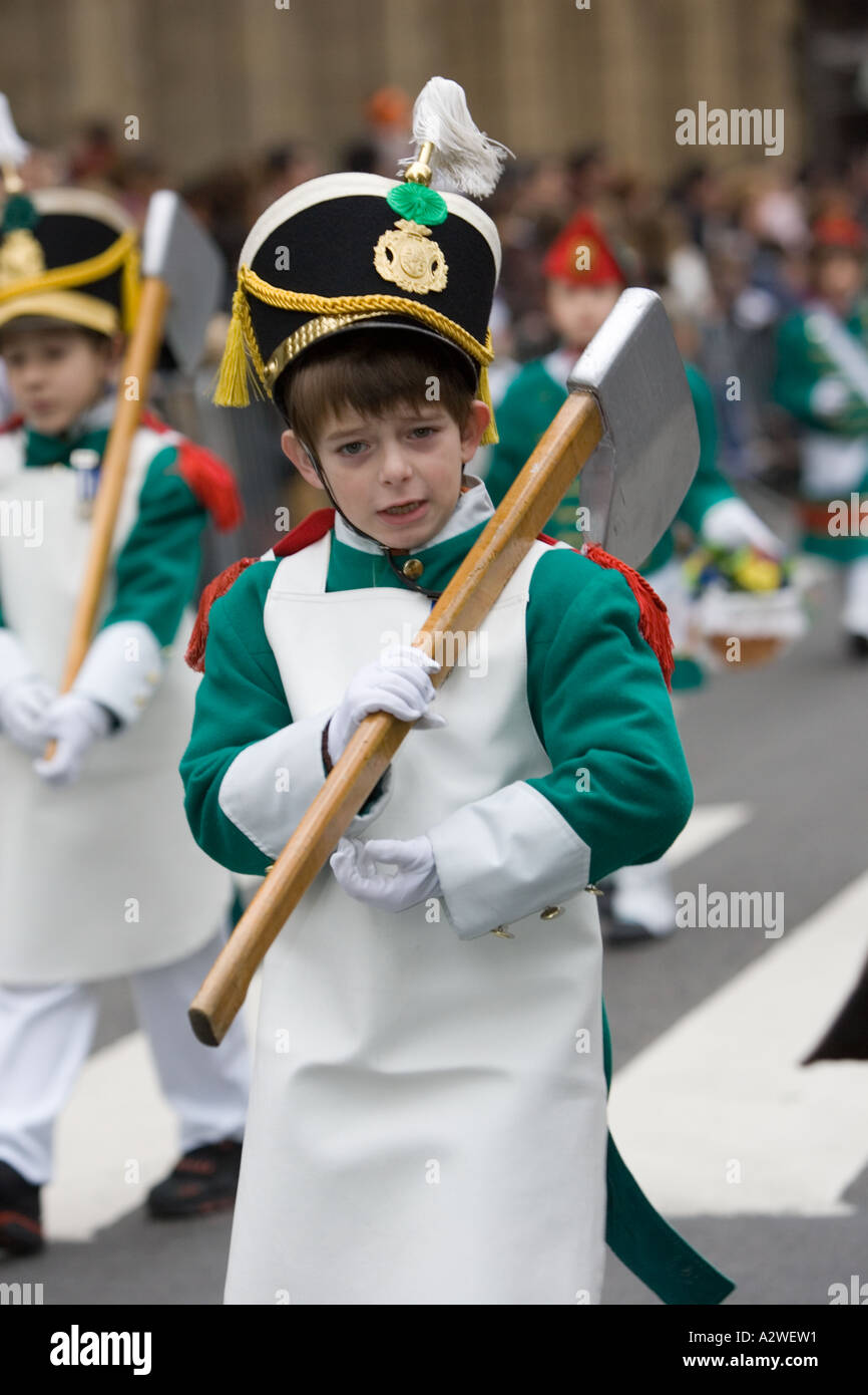 A Basque boy in military uniform parades through the streets of ...