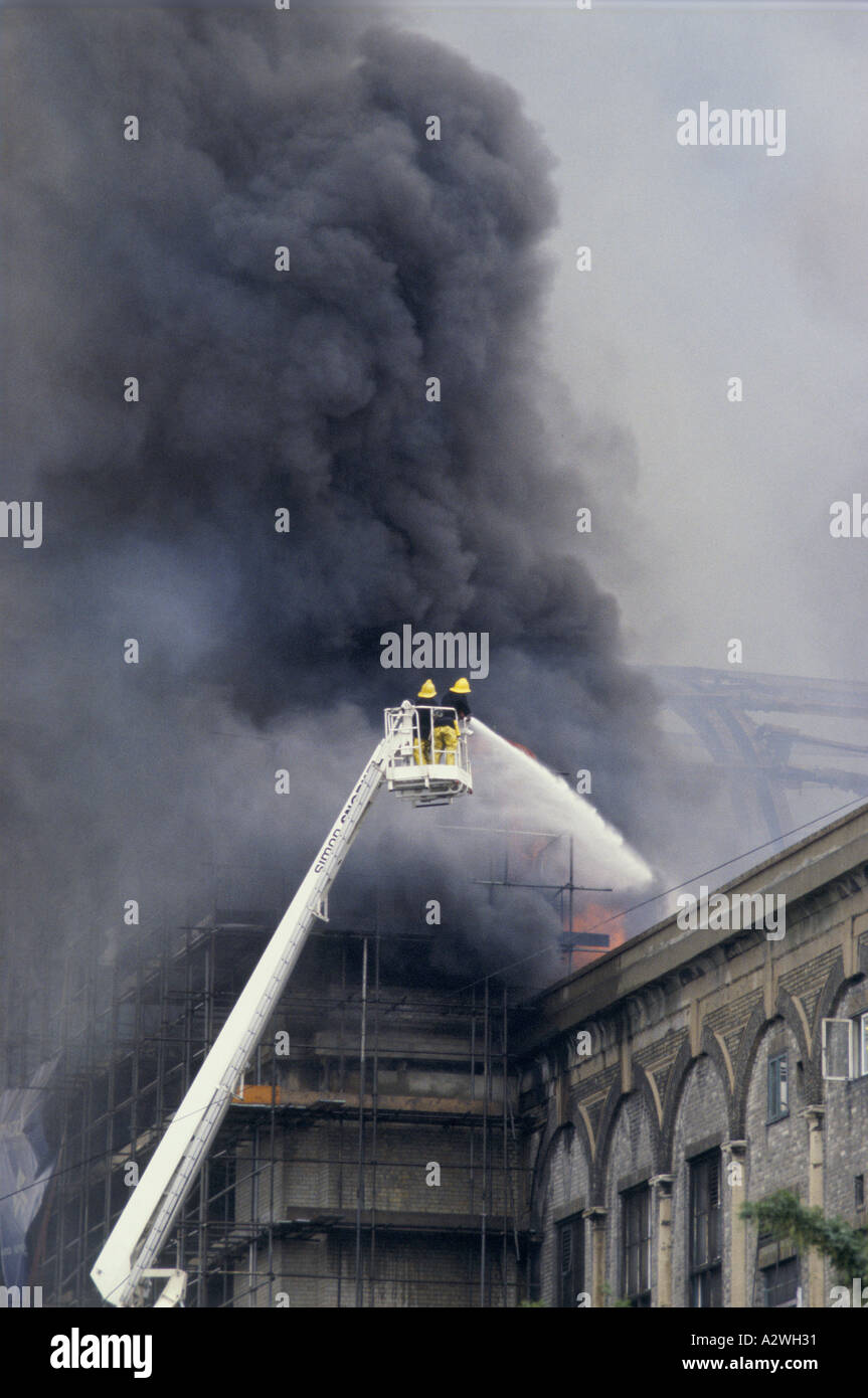 fireman douse flames using water cannon from platform on the top of a ...