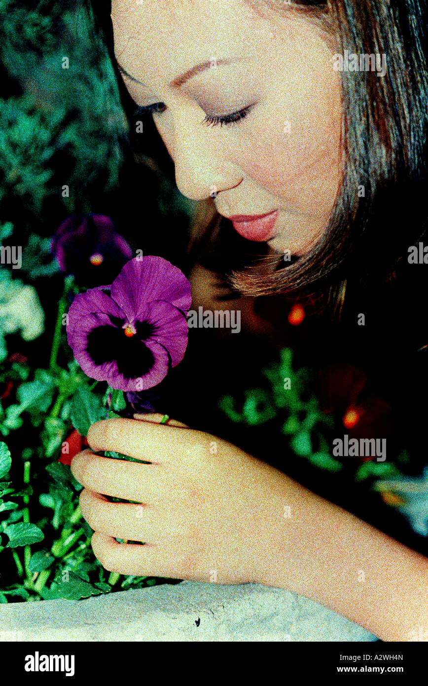 Young woman smelling flower Stock Photo - Alamy