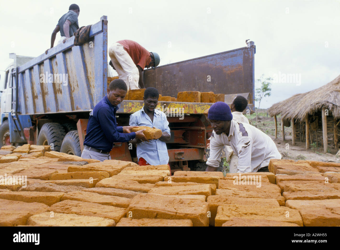 men loading red bricks onto a truck at brick making co op Messica Stock ...