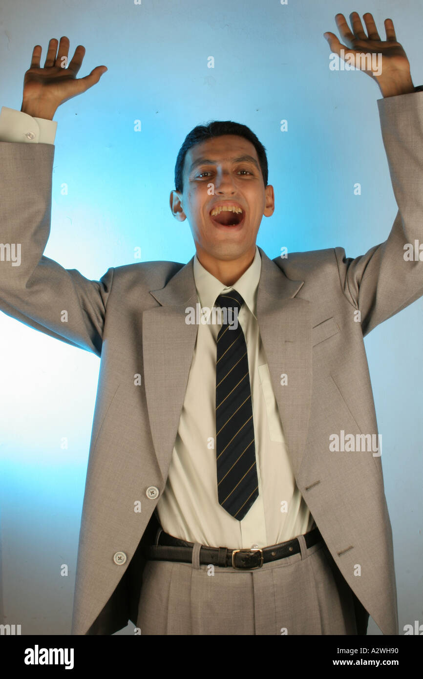Man with hands raised laughing, executive dress in suit and tie - Model ...