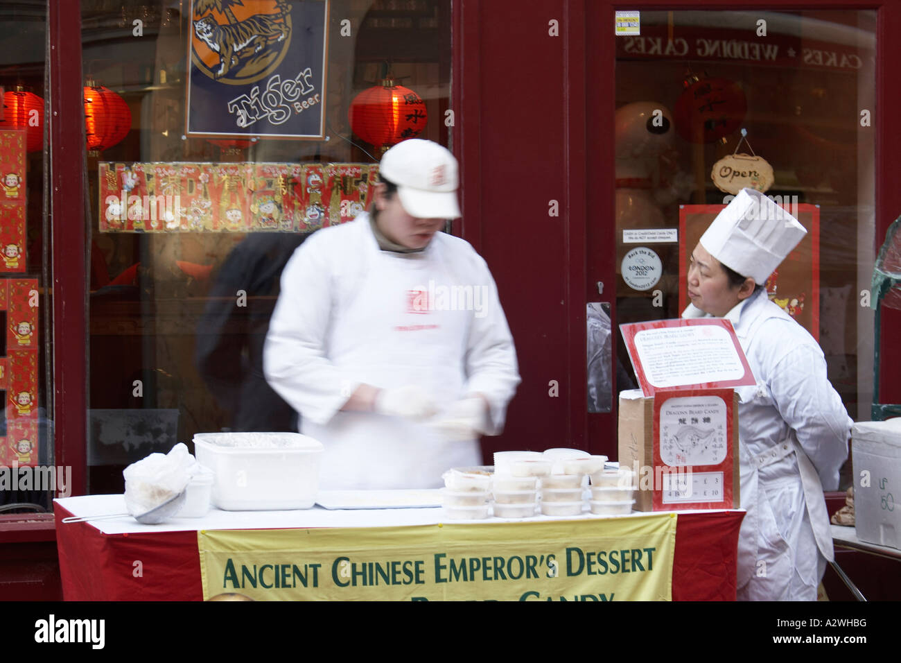 Two Chinese chefs cooking outside restaurant in Chinatown soho London ...