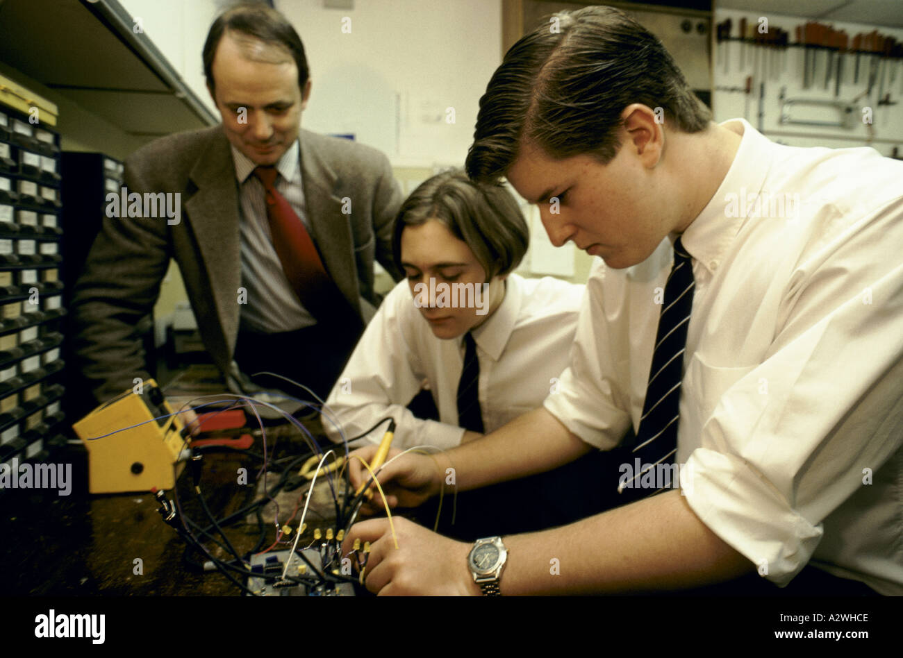 teenage pupils wiring circuit board at science class london forrest ...