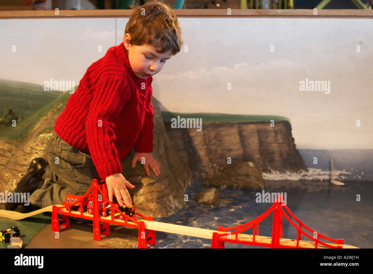 Young boy child playing with model railway train toy in Odyssey W5 ...