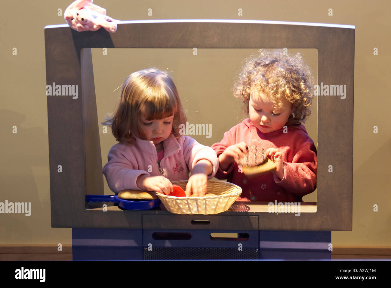 Two young girls or children playing in toy TV screenin Odyssey W5 ...