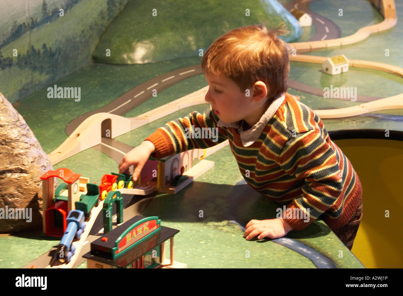 Young boy child playing with model railway toy in Odyssey W5 ...